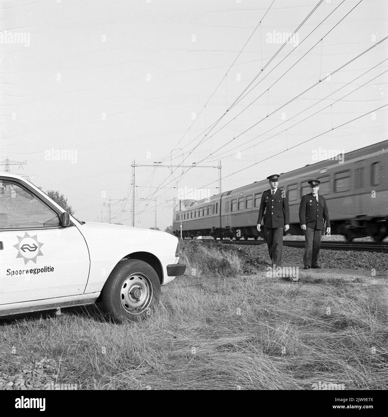 Image of two agents of the railway police with their car during a ...