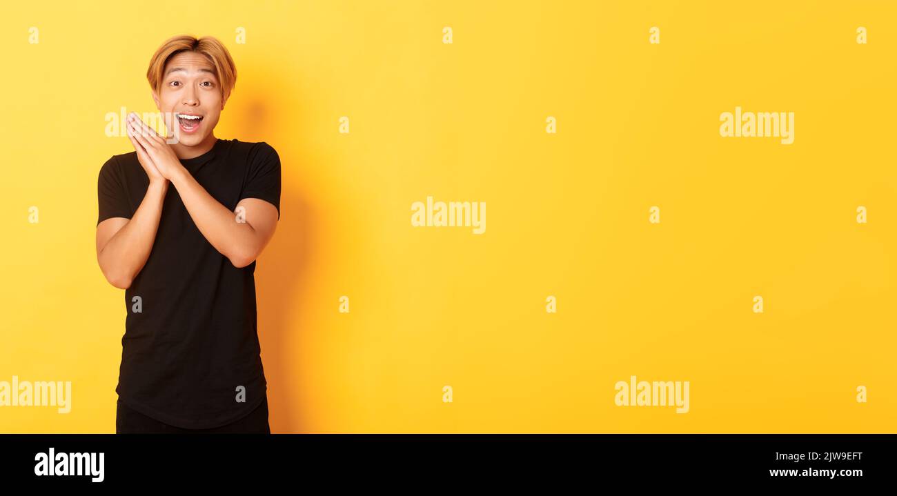 Portrait of happy and surprised asian man clap hands and smiling ...