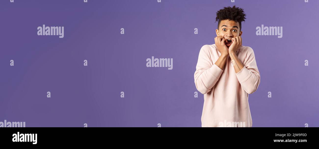 Portrait of young scared guy watching really scary movie, horror alone ...