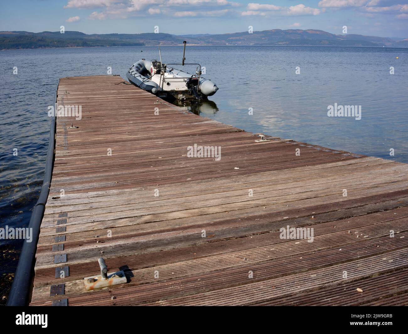 On a bright spring afternoon in March, an inflatable dinghy lies moored ...