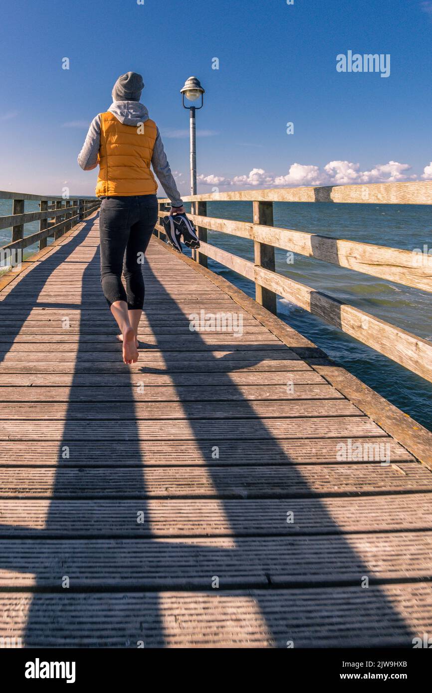 Barefoot woman on a bridge Stock Photo - Alamy