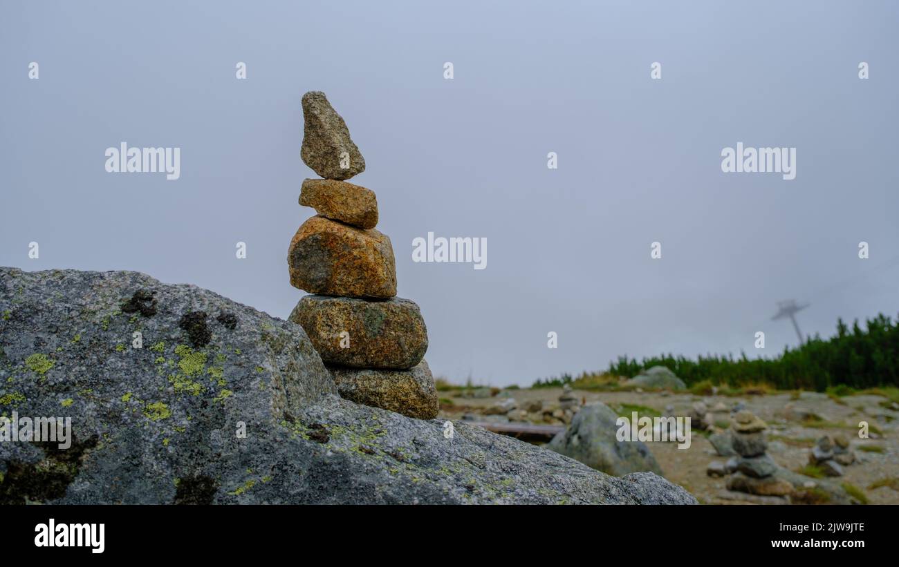 Many stone statues, pyramids are piled on the big rock Stock Photo - Alamy