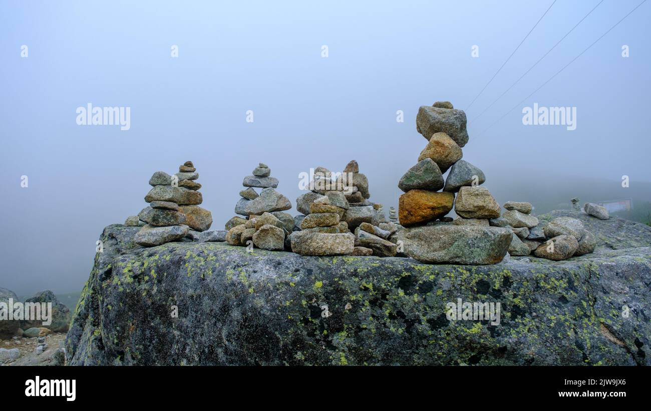 Many stone statues, pyramids are piled on the big rock Stock Photo - Alamy