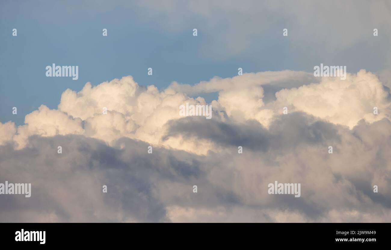 Puff Clouds in the Sky during sunset Stock Photo - Alamy