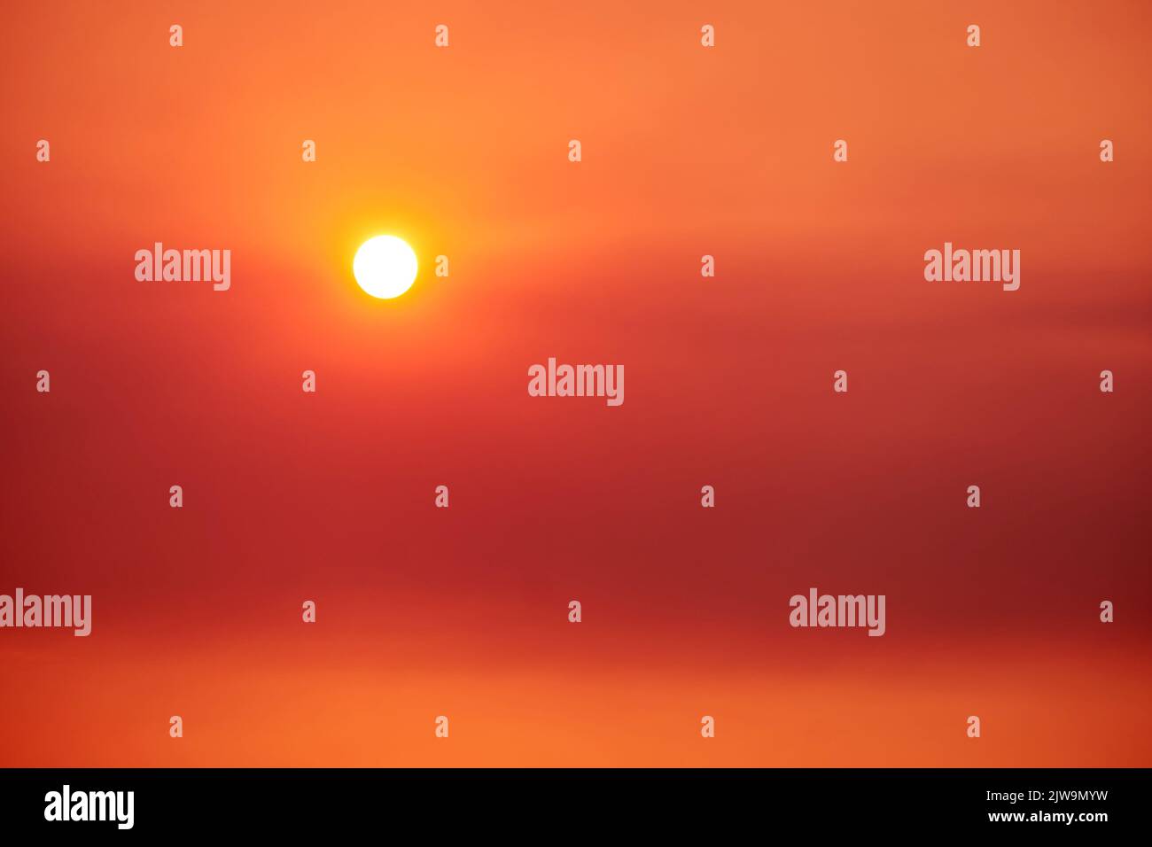 A big red sun in the sunset sky, a summer landscape. Evening sky in hot ...