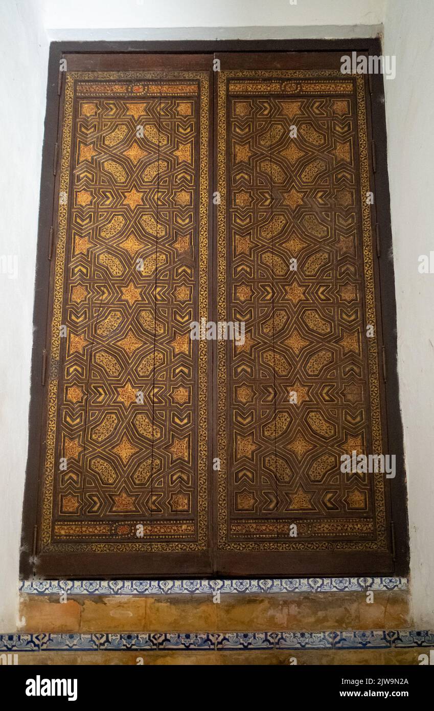 Inlaid wooden door in mudejar pattern, Alcazar of Seville Stock Photo ...