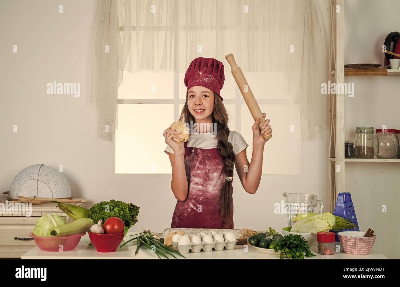 Helpful tools. teen girl chef wearing uniform. child study how to cook ...