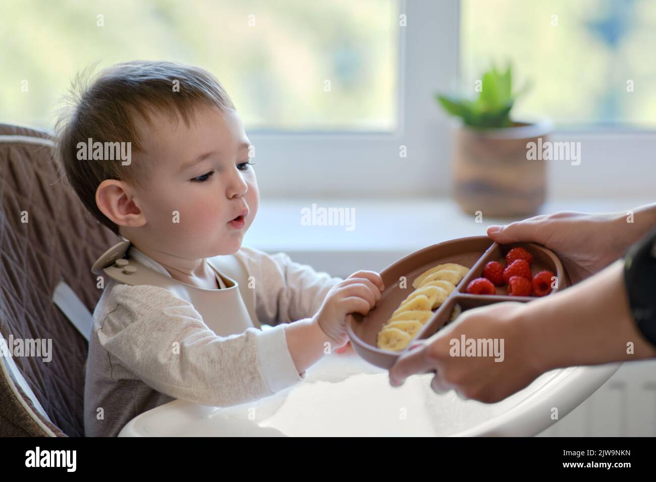 Woman gives child food hi-res stock photography and images - Alamy