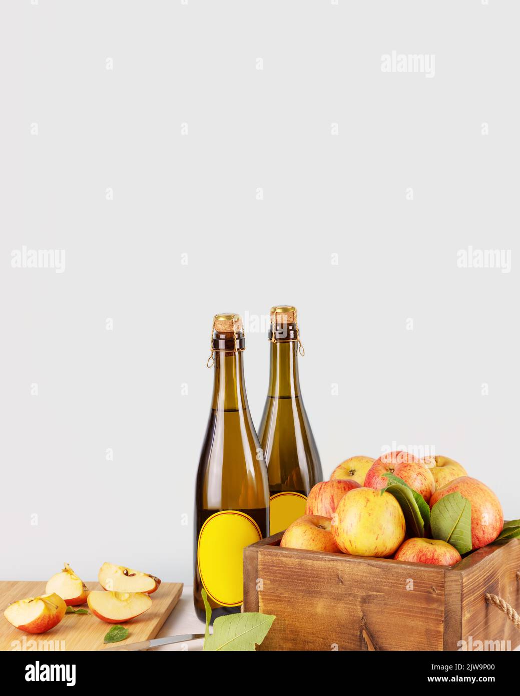 Apple cider drink or fermented fruit drink. Bottles with cider and red ...