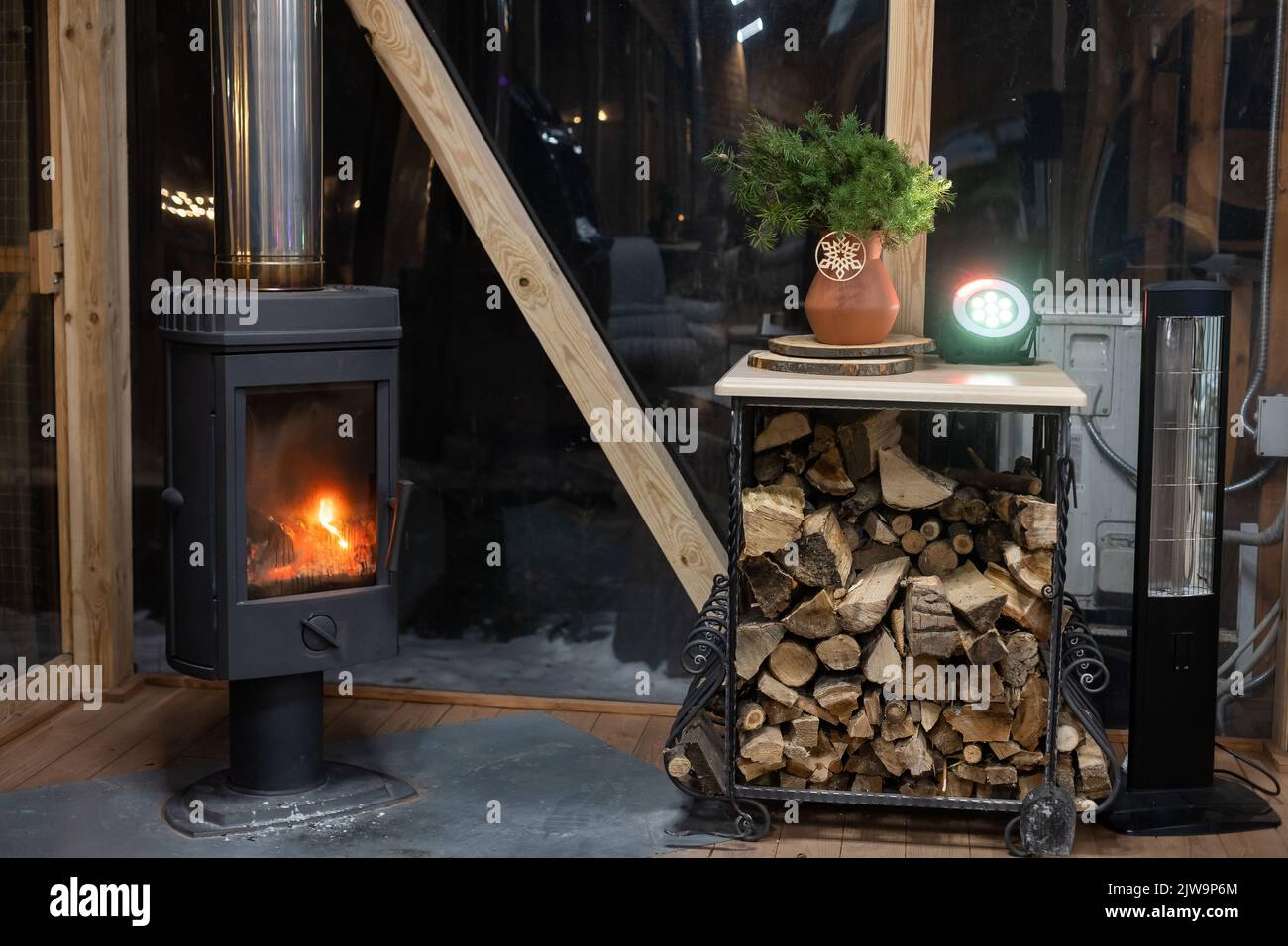 Concept of fireplace with fire at home. Comfortable living room with ...