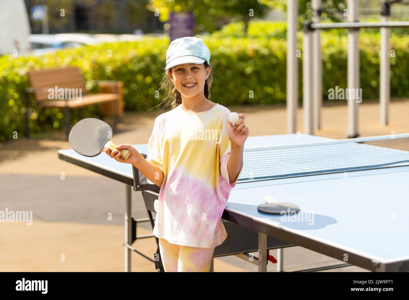 little girl playing table tennis in the tennis hall, tennis racket ...
