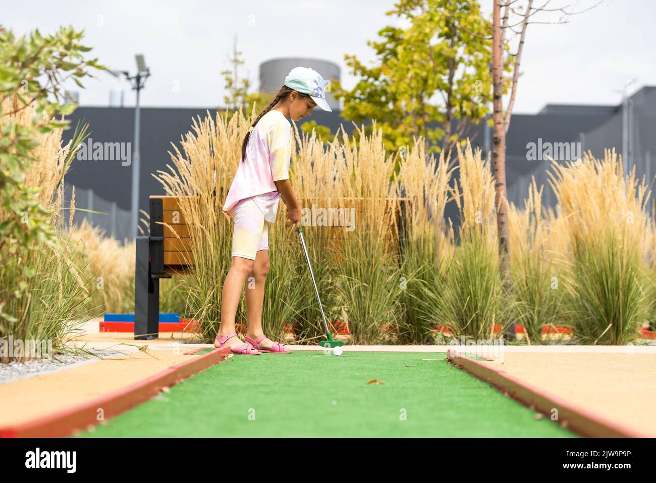 cute little girl on a miniature golf course Stock Photo - Alamy