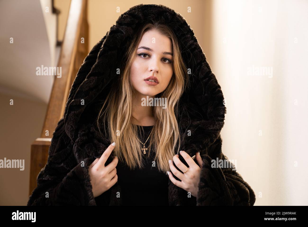 A Portrait of a blonde pretty girl in a black heavy winter jacket Stock ...
