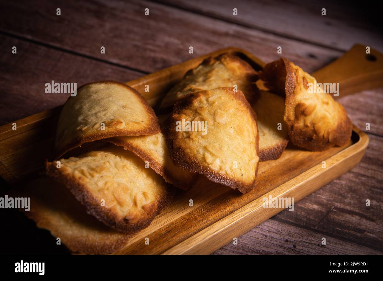 French delicacy pastry tuile with almond on wood background Stock Photo ...