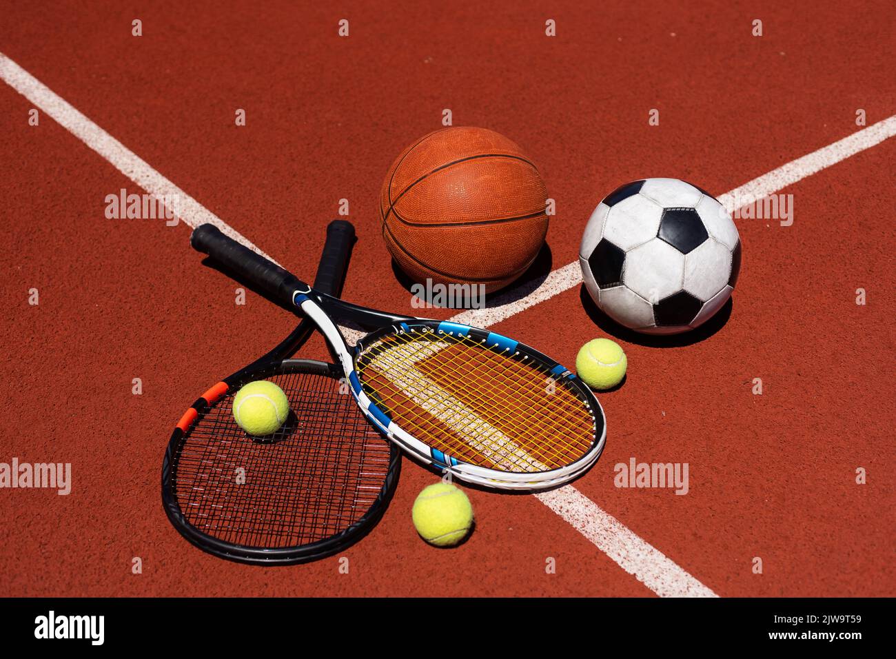 A group of sports equipment on black background including tennis ...