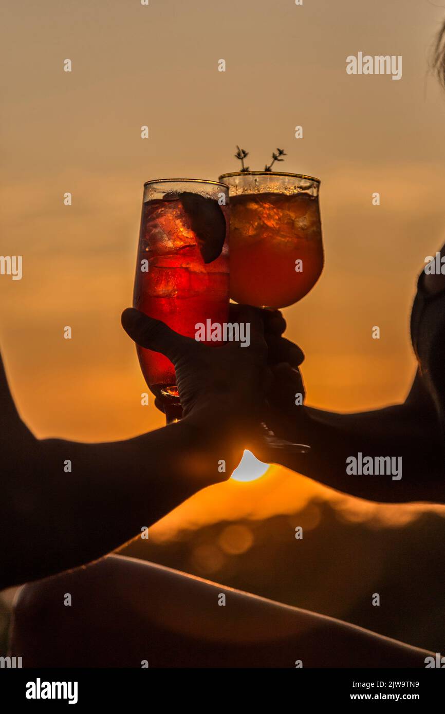 Toast with two cocktails during happy hour at a bar. Enjoying a few ...