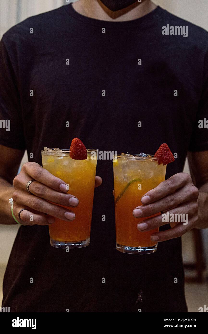Bartender showing the customer the drink he has just prepared. Night ...