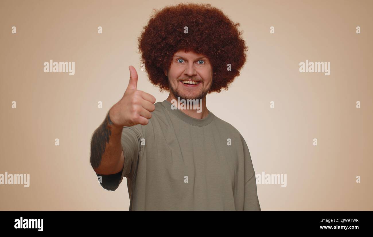 Like. Bearded adult man with lush coiffure raises thumbs up agrees with ...