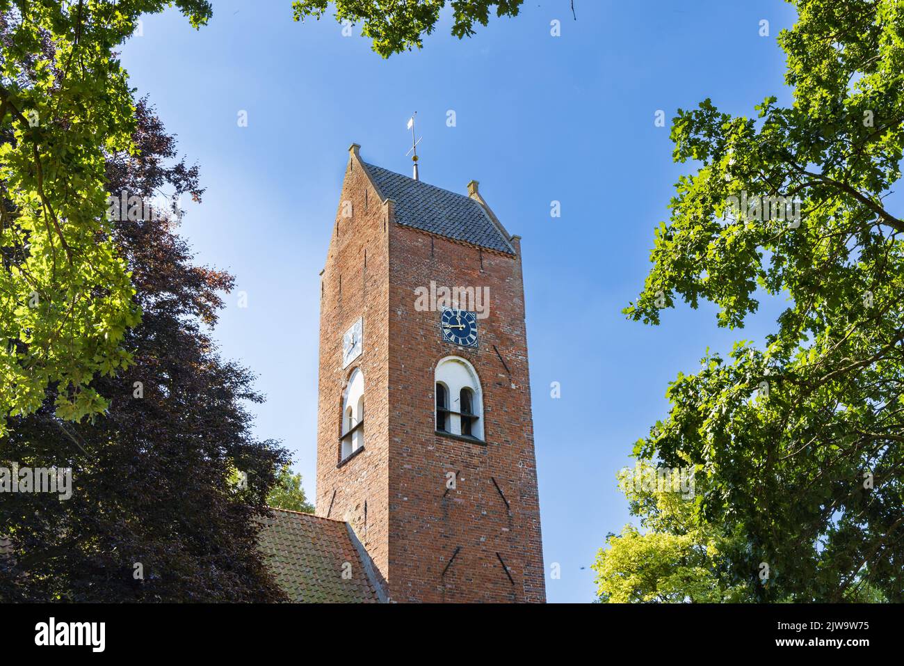 Classic church from 13th century surrounded by big trees in Tolbert ...