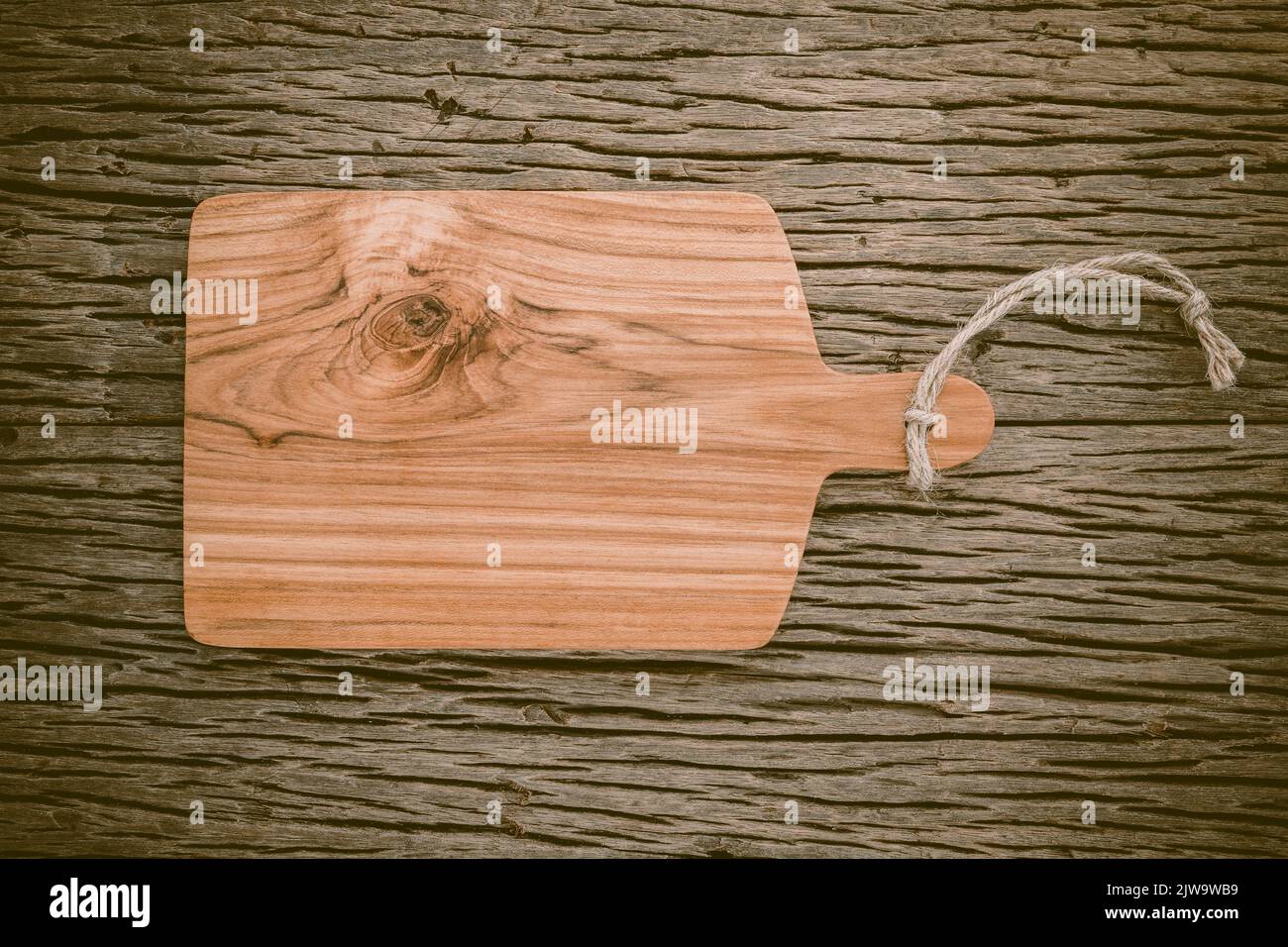 A top view of a kitchen board on a wooden background Stock Photo - Alamy