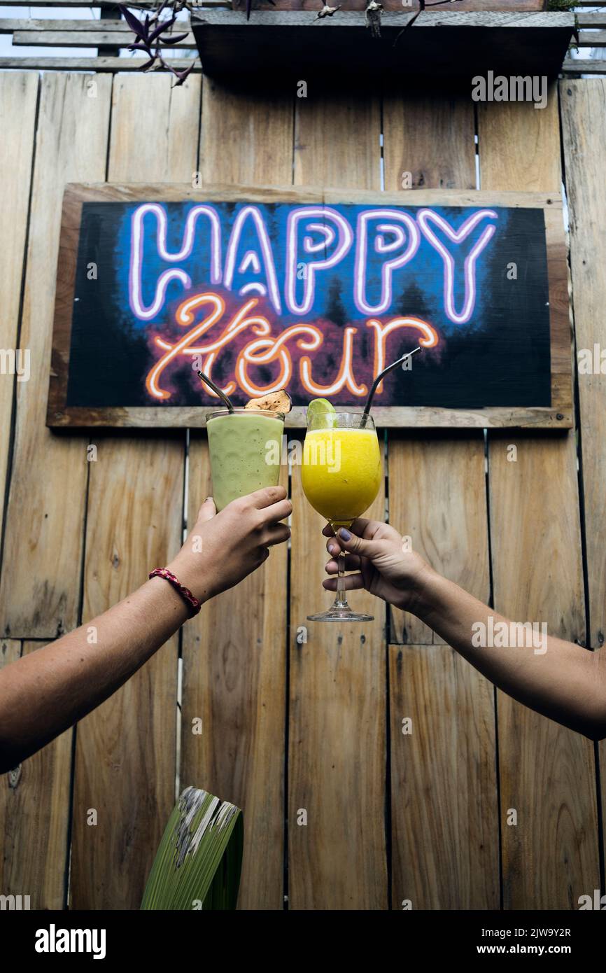 Toast with two cocktails during happy hour at a bar. Enjoying a few ...