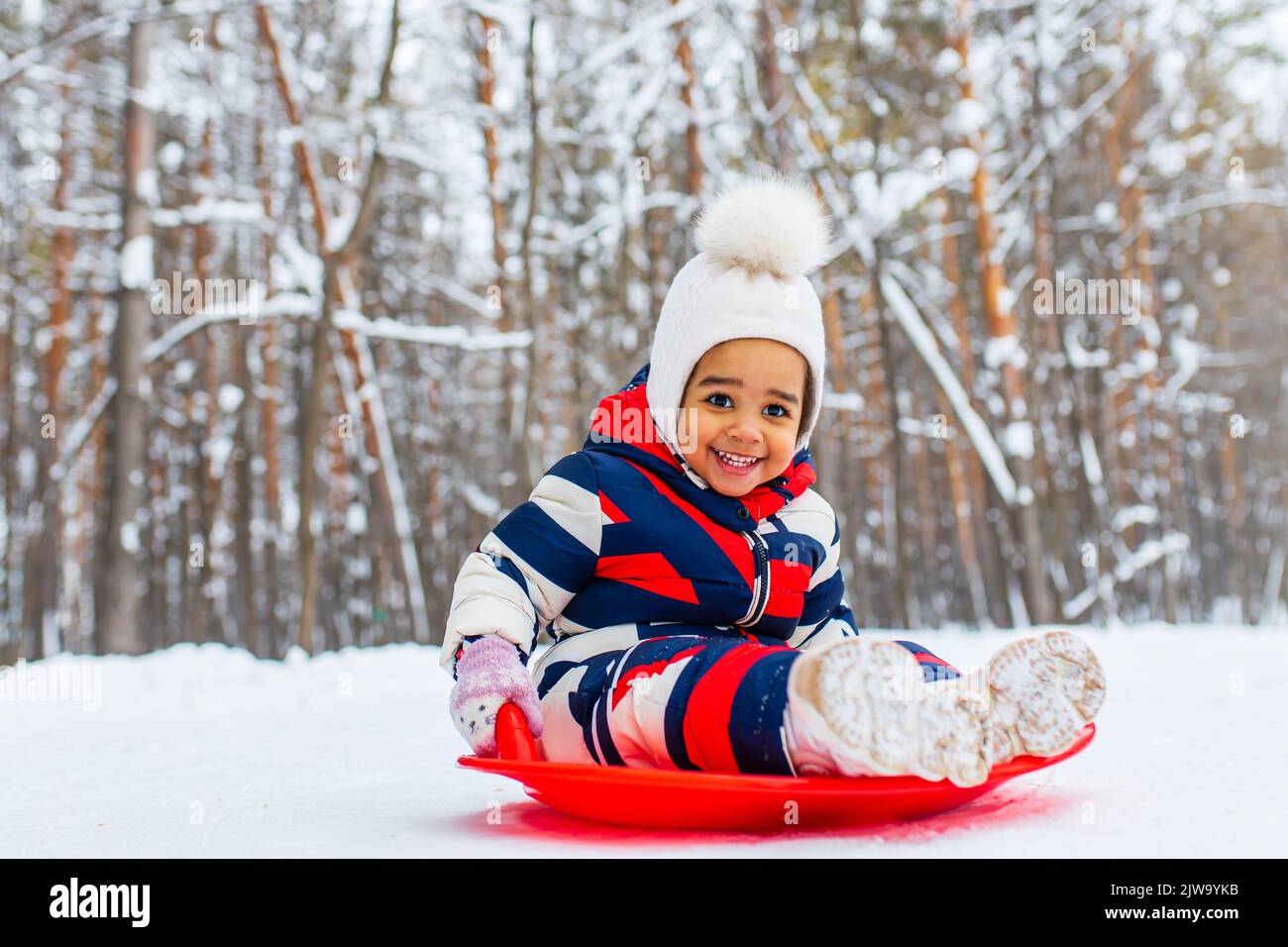 little girl having fun and sledding sled playing in snowy park Stock ...