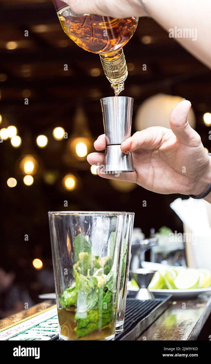 Bartender serving alcohol in a cocktail. Cocktail preparation in a ...