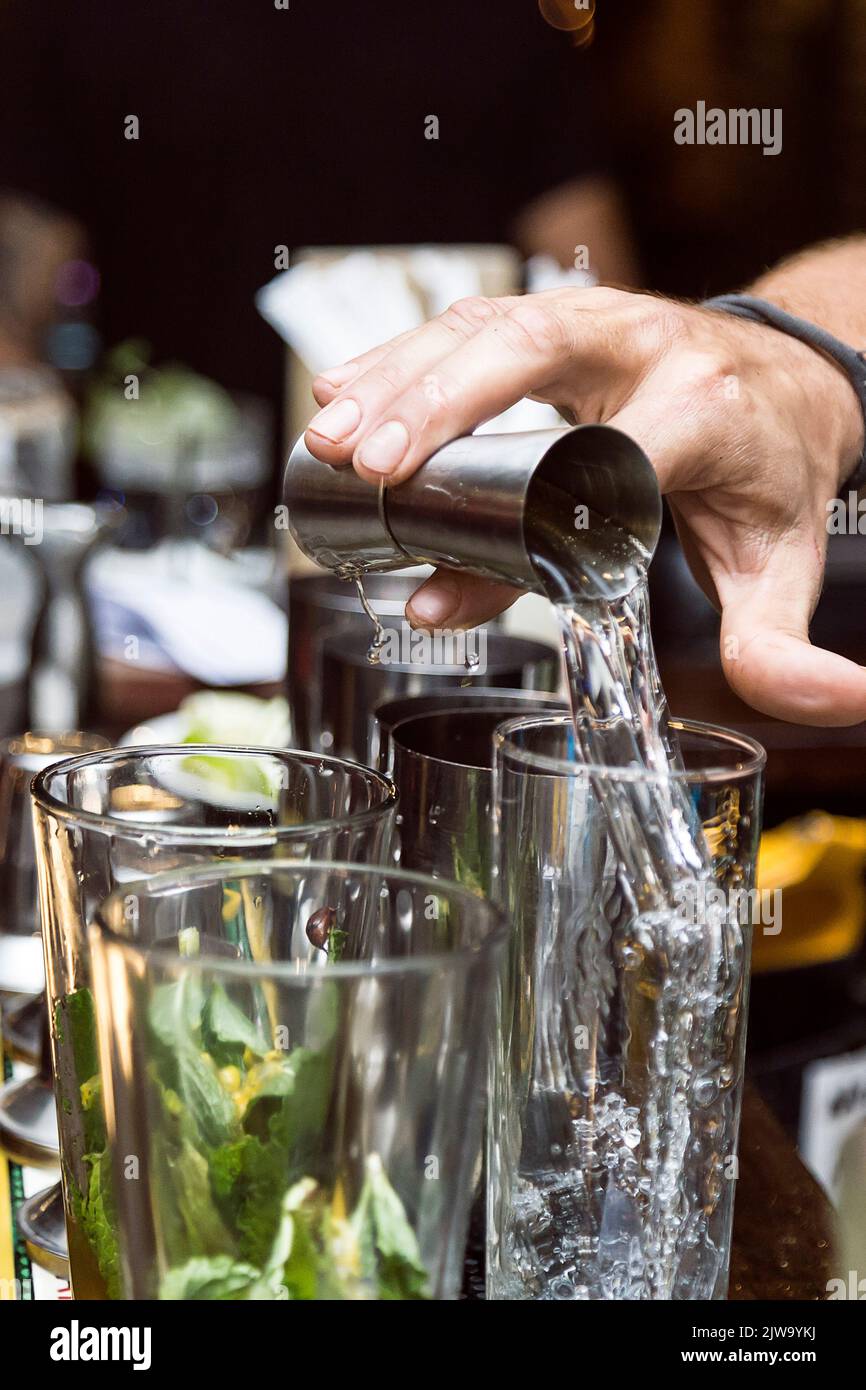 Bartender serving alcohol in a cocktail. Cocktail preparation in a ...