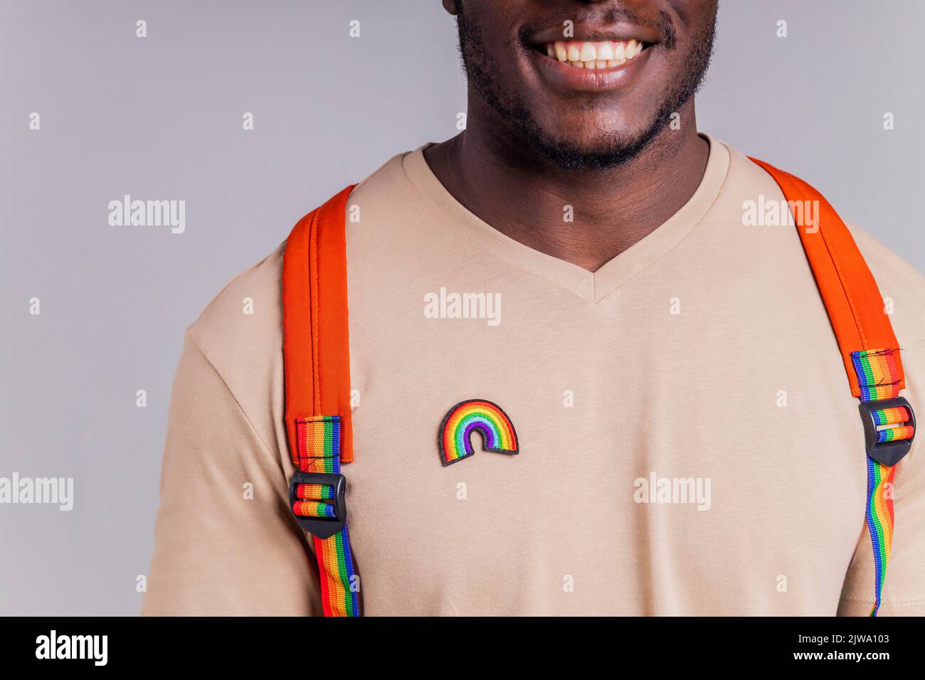 african american man student with backpack in studio smiling at the ...