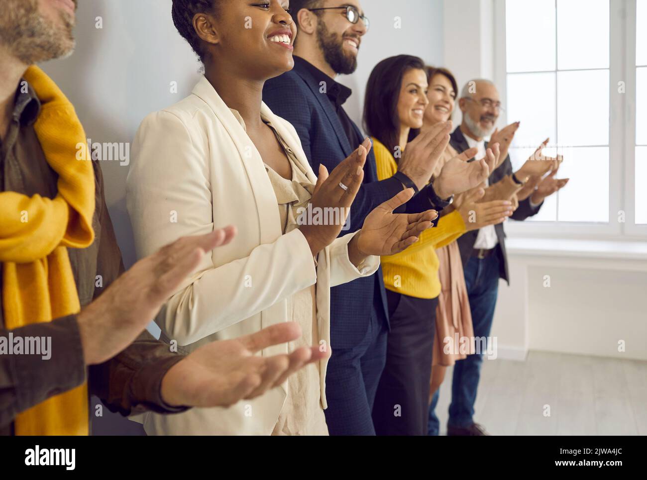 Happy diverse employees clap hands show acknowledgement Stock Photo - Alamy
