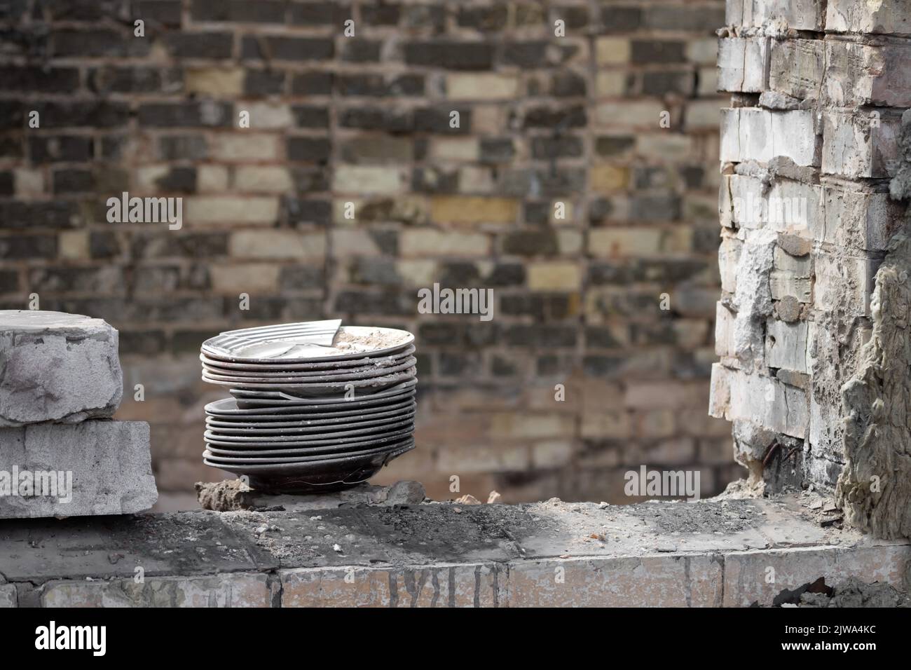A stack of plates in the middle of a war-torn house. Findings of things ...