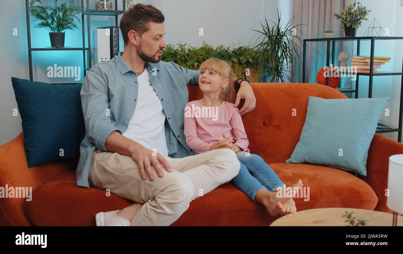 Young loving man dad talking to little 7s daughter toddler together on ...