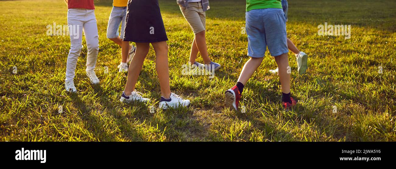 Group of little children playing in the park, dancing round dance and ...