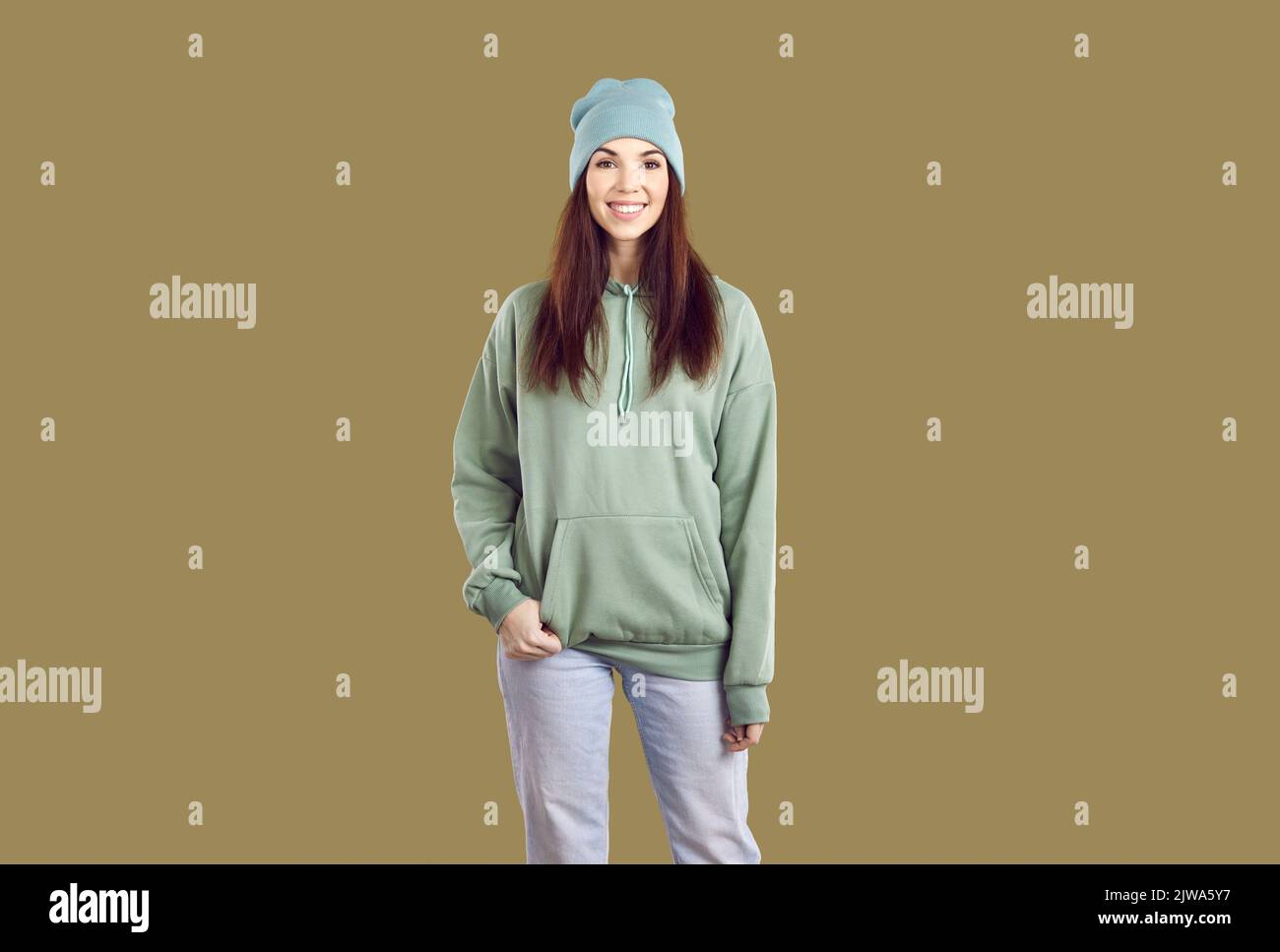 Studio portrait of happy young woman or teenage girl in comfortable ...