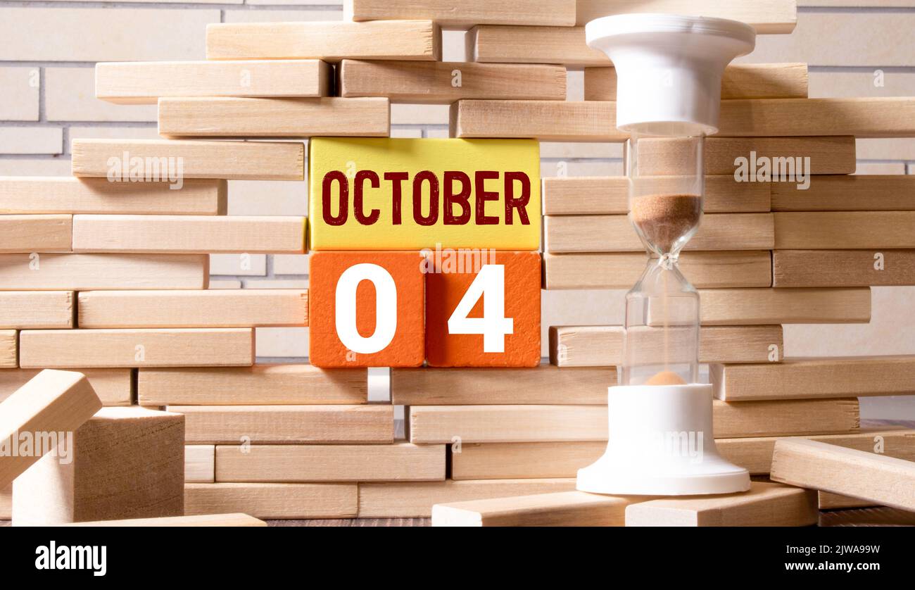 White block calendar present date 4 and month October on wood ba Stock ...