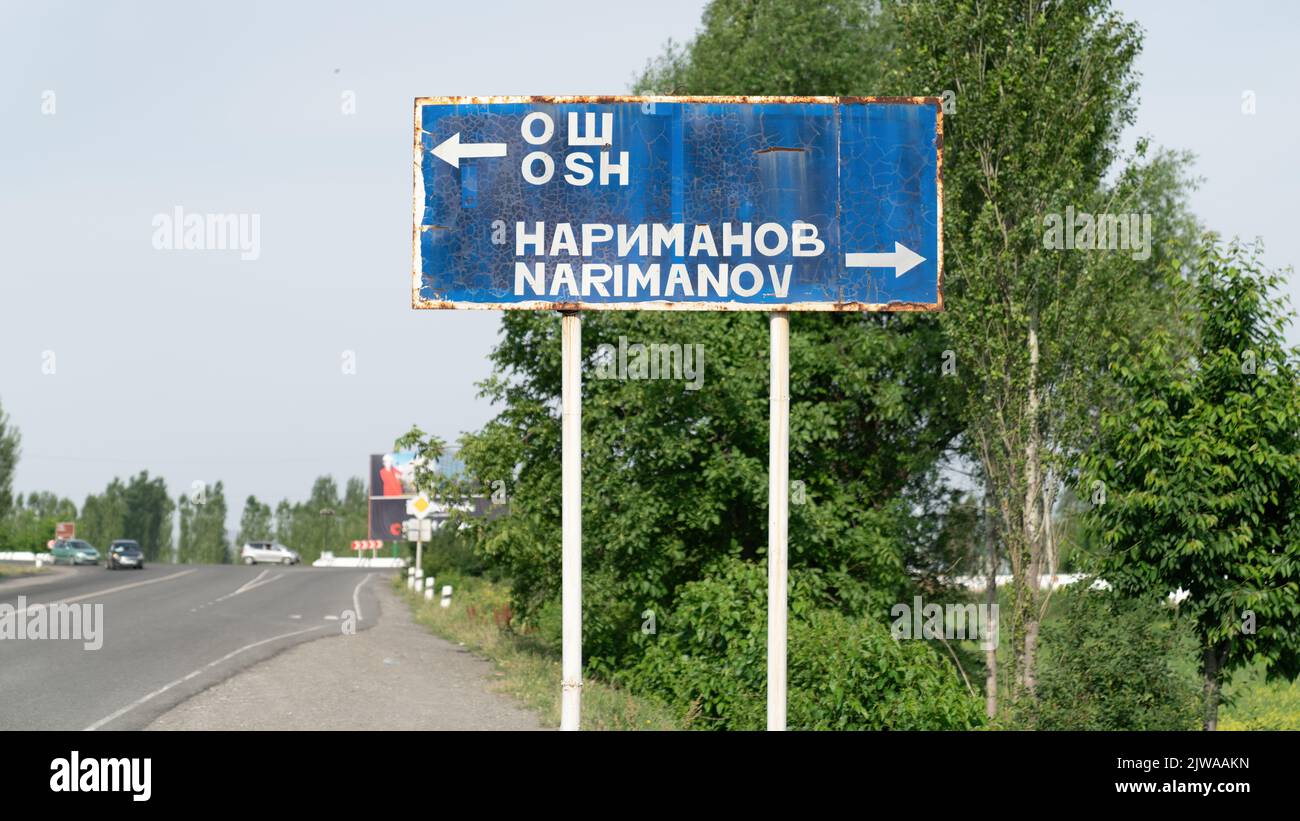 Traffic directional sign showing Osh and Narimanov city directions ...