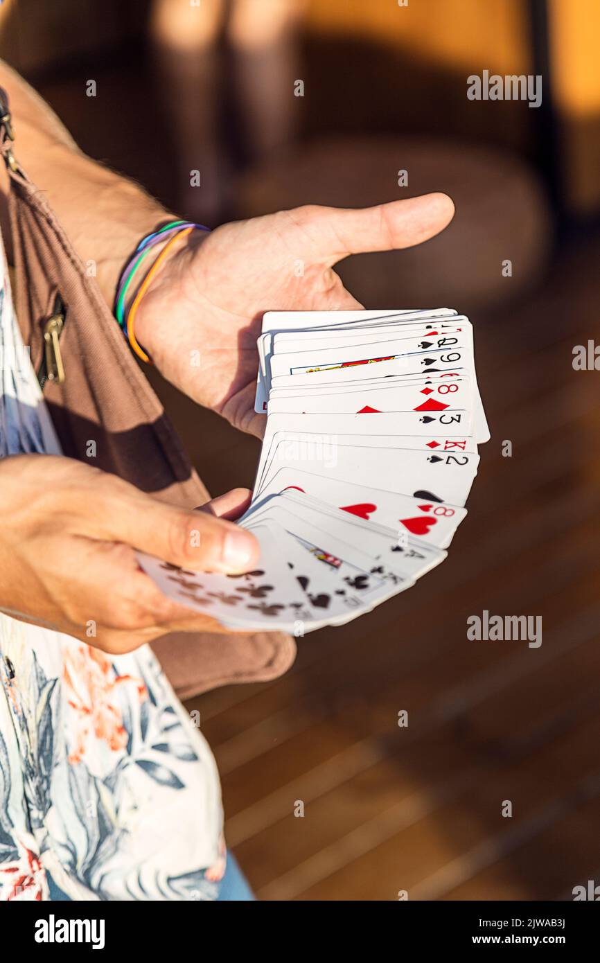 Magician showing the cards in his hand. Magic show Stock Photo - Alamy