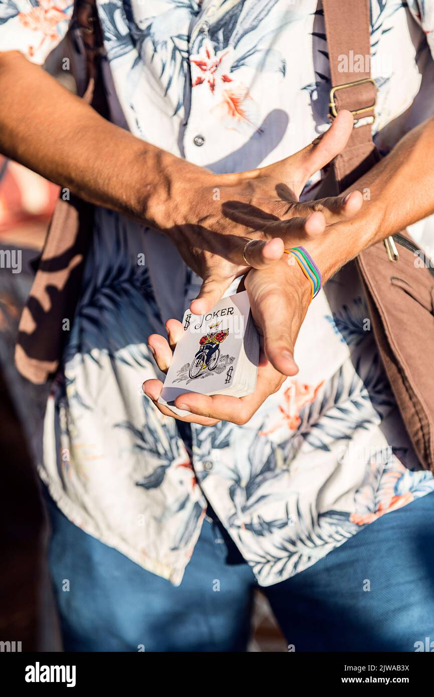 Magician showing the cards in his hand. Magic show Stock Photo - Alamy