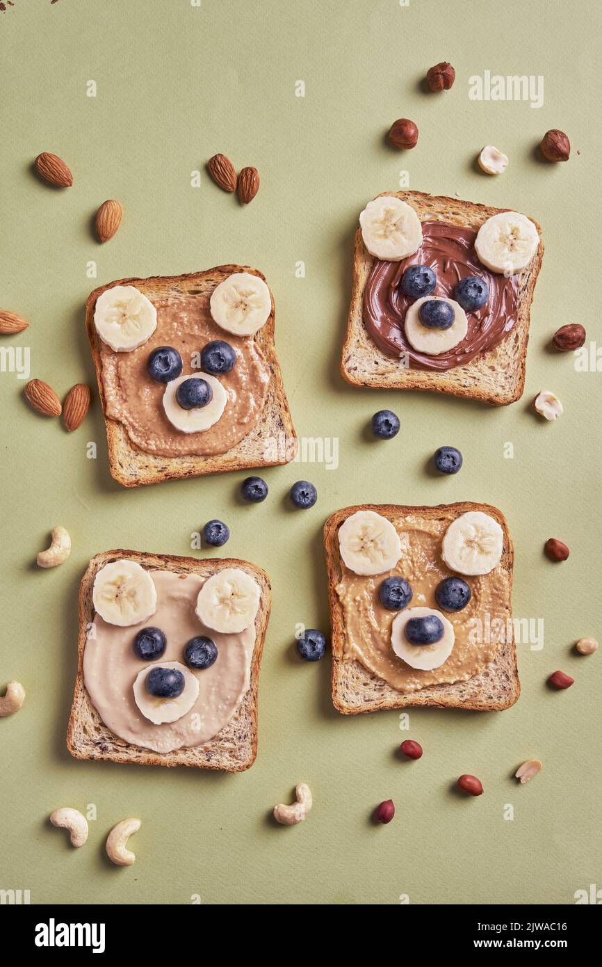 Funny children bear toasts with nuts butters Stock Photo - Alamy