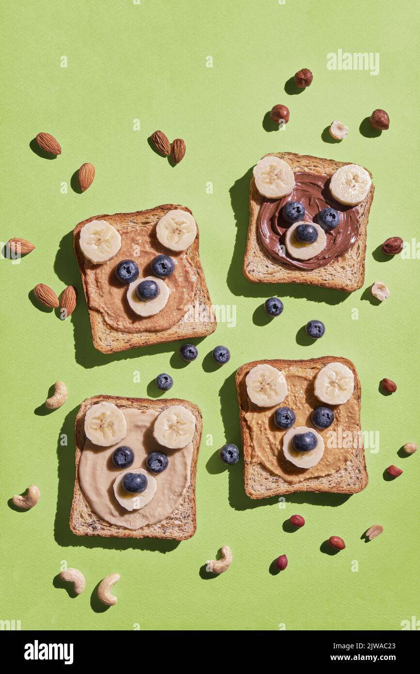Funny children bear toasts with nuts butters Stock Photo - Alamy