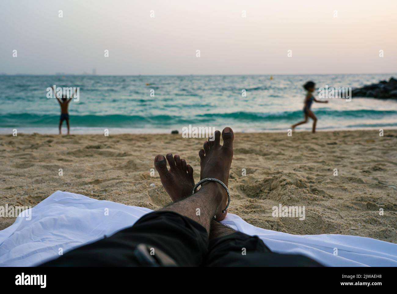 a single father is chilling with children concept in Jumeirah beach ...