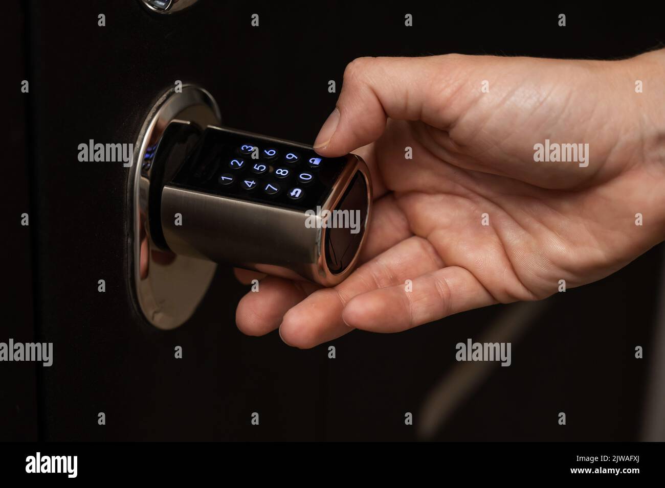 Woman opens the combination lock on the door to the apartment. Keyless ...