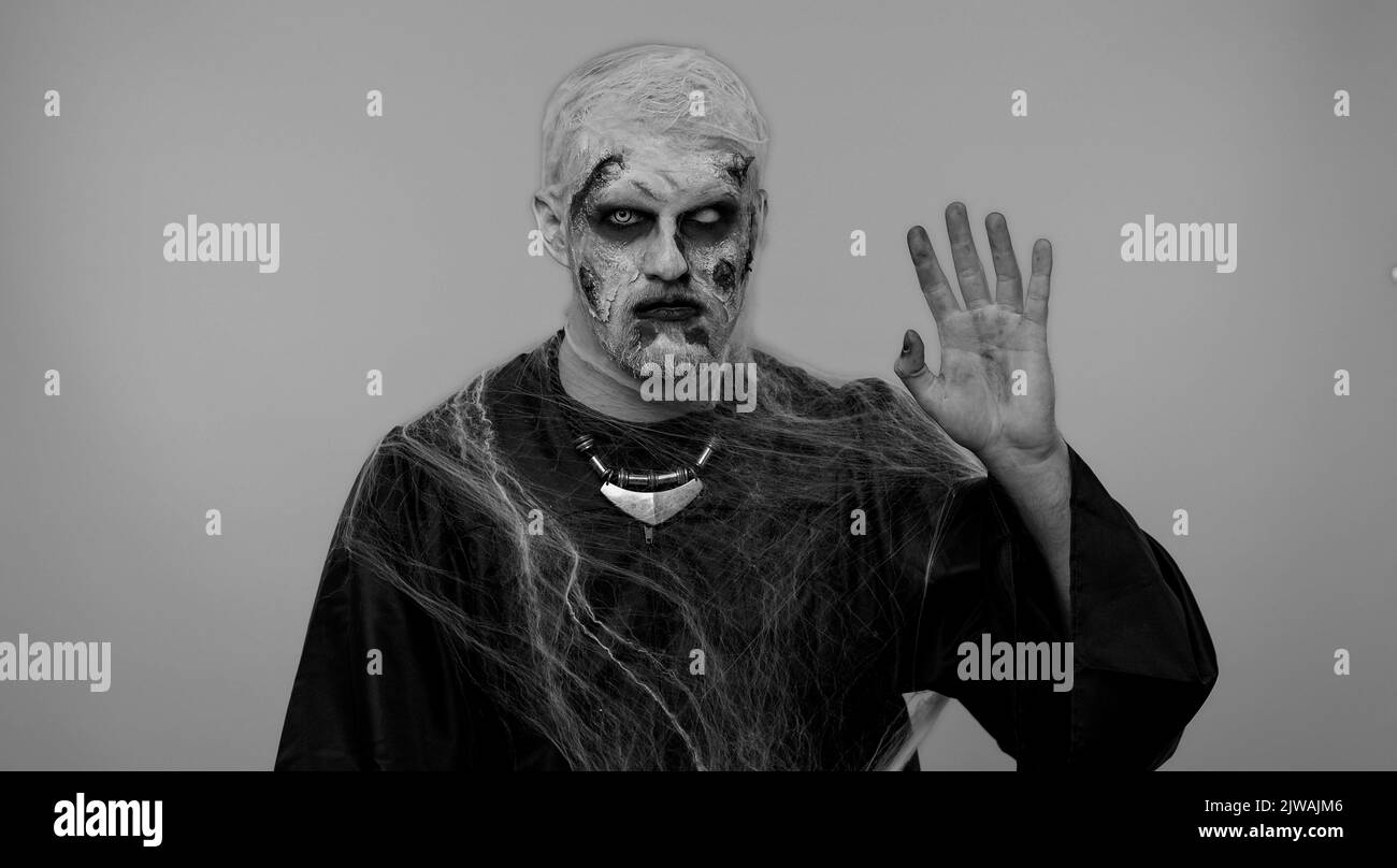 Creepy scary man with bloody scars face, Halloween zombie make-up ...