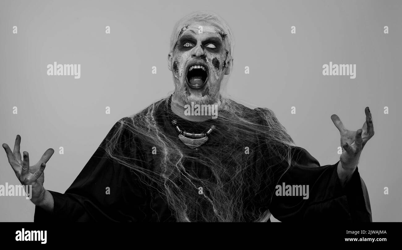 Sinister man in carnival costume of Halloween crazy zombie with bloody ...