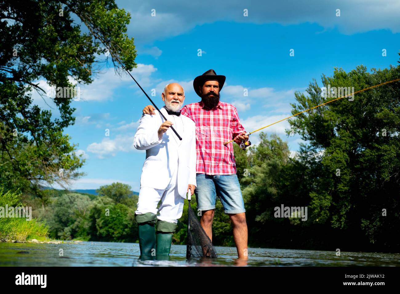 Men fishing. Fishing anglers in river water. Old and young fisherman ...