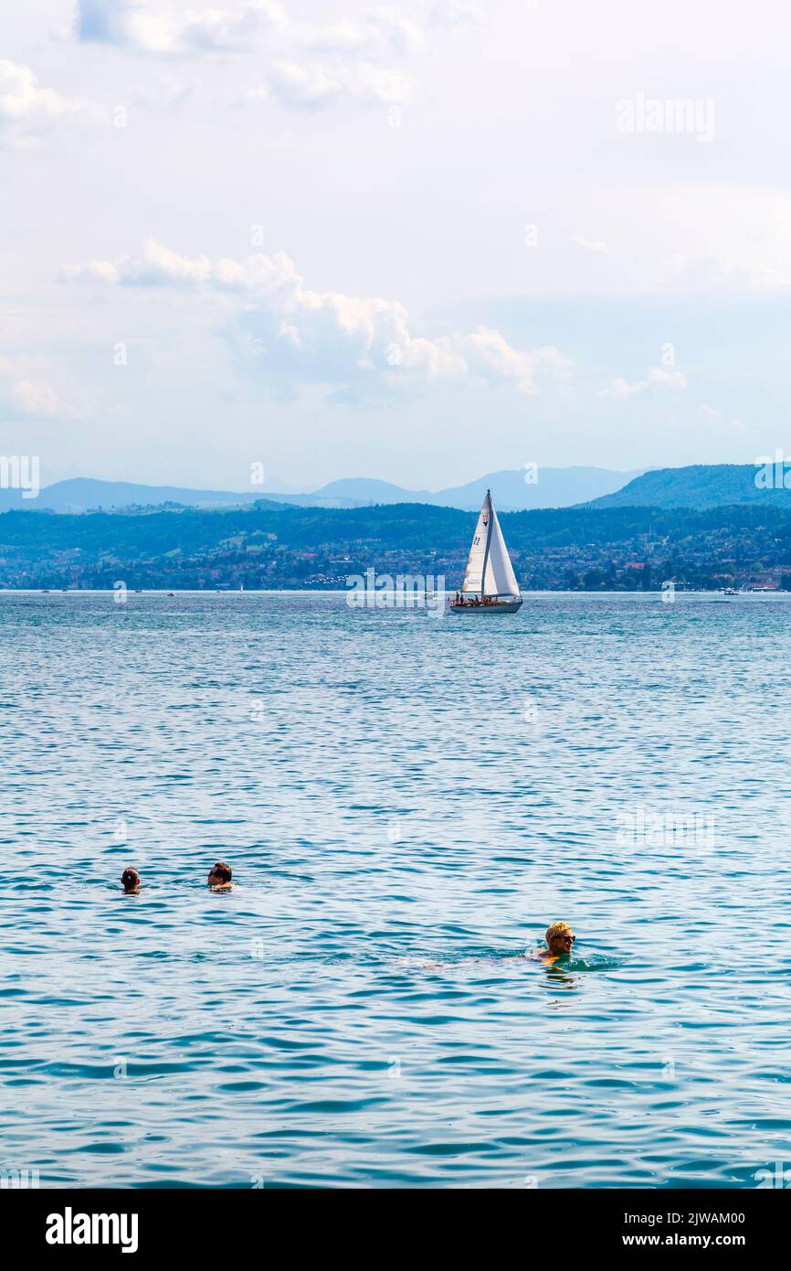 Sailboat on Lake Zurich and people swimming on a summer day, Zurich ...