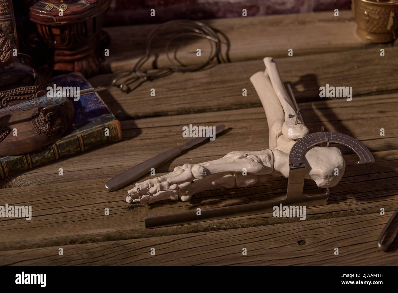 Old doctor's desk. still life of instruments and bone parts typical of ...