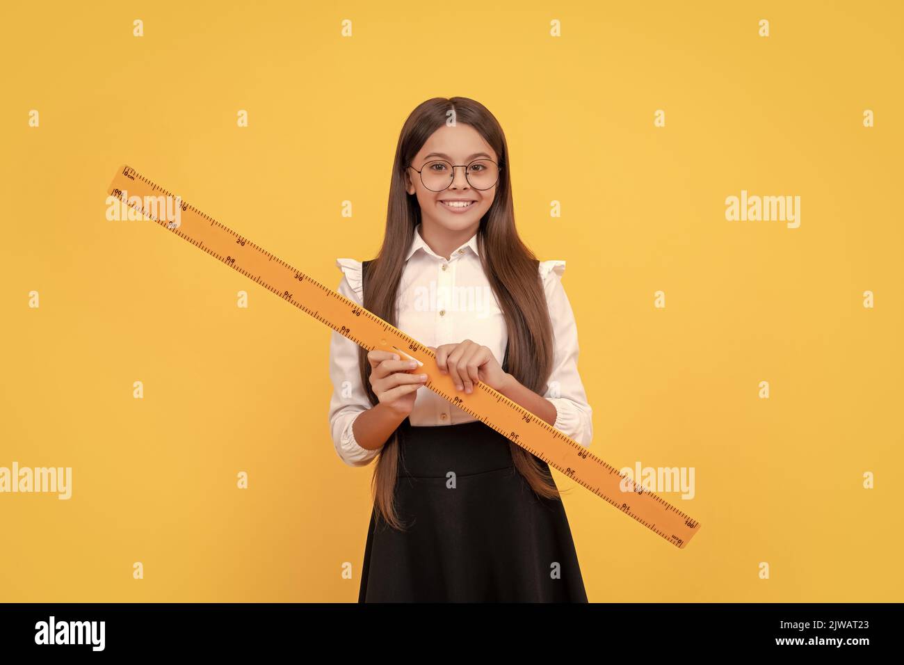 smiling tween girl hold ruler. back to school. algebra and geometry ...