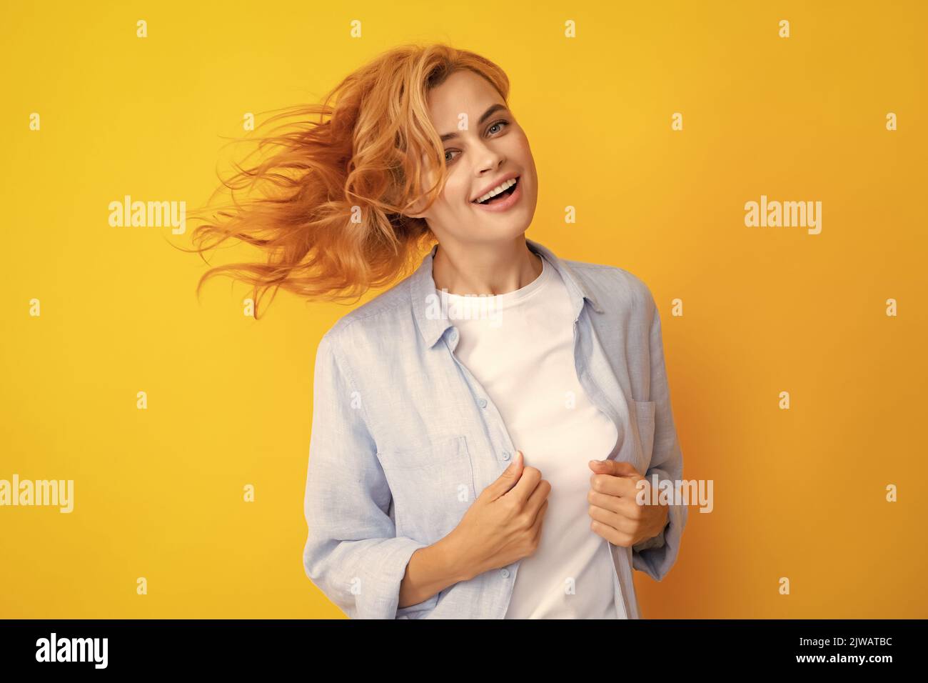 Redhead woman with movement hair. Studio shot of carefree redhead woman ...