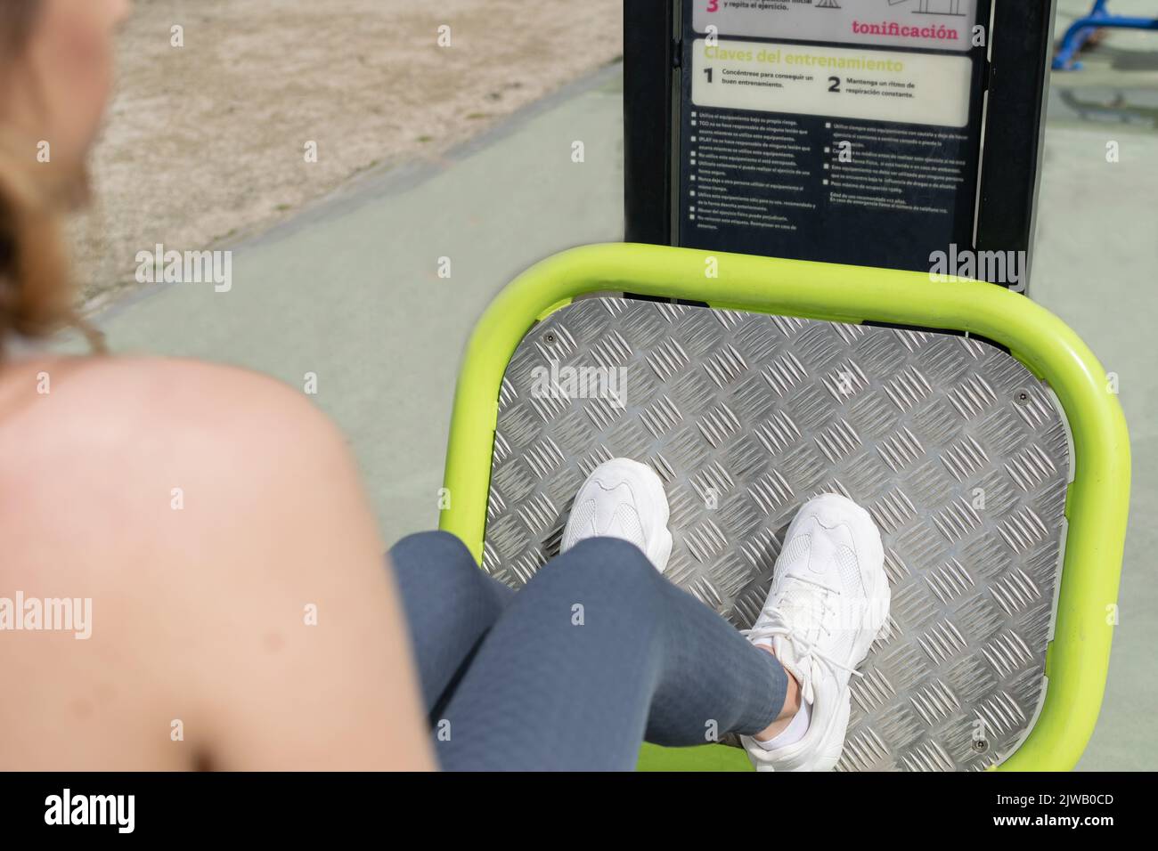 young woman exercising in outdoor gym cropped image, athlete body ...